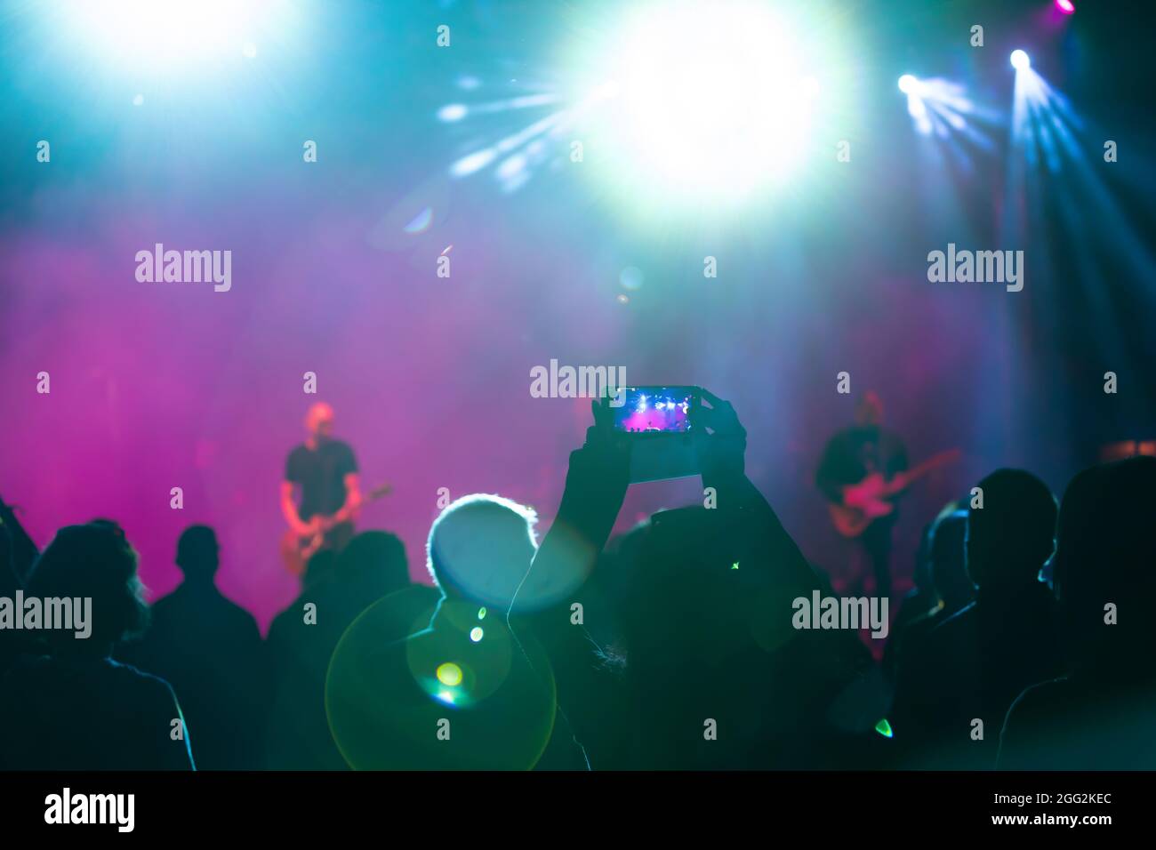 Crowd at concert - Cheering crowd in bright colorful stage lights Stock ...