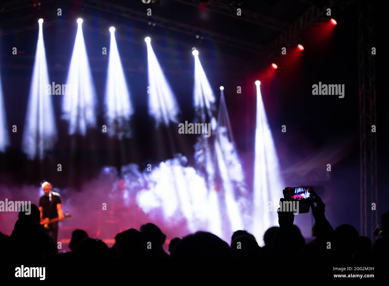 Crowd at concert - Cheering crowd in bright colorful stage lights Stock ...