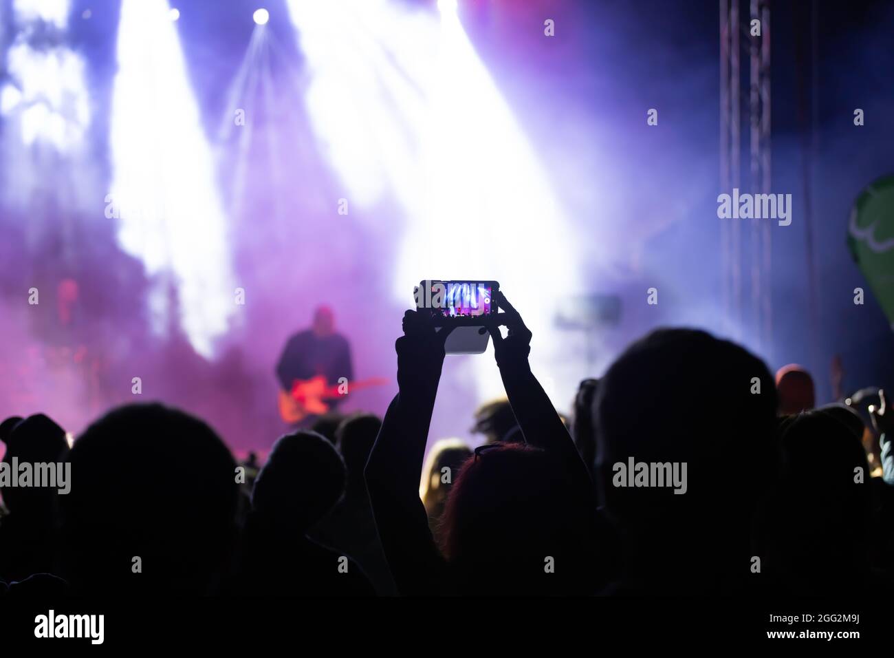 Crowd at concert - Cheering crowd in bright colorful stage lights Stock ...
