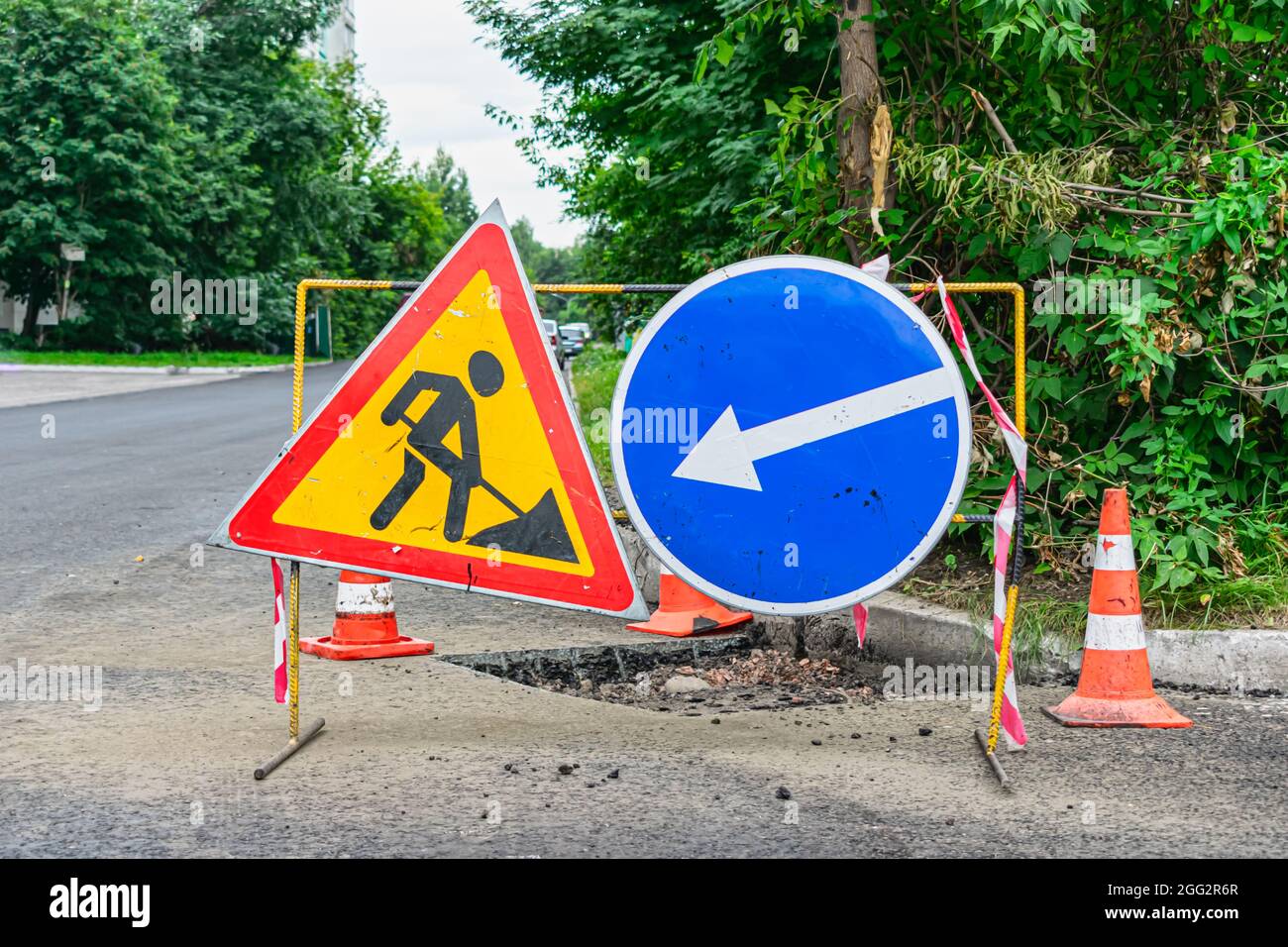 Road signs indicating the repair of asphalt and the direction to bypass ...