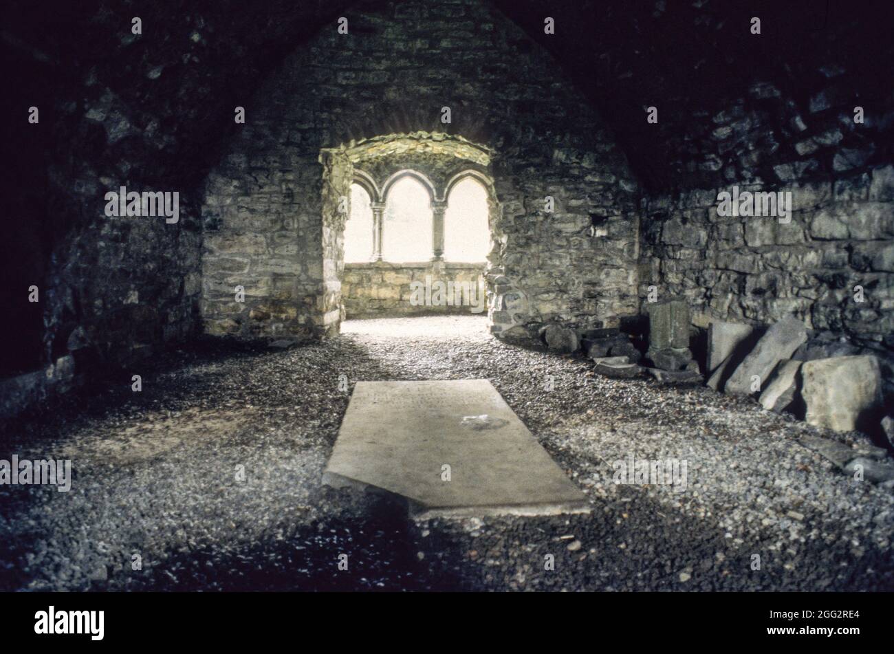 Tomb slab in a chamber of Sligo Abbey with a door to the cloister-walk ...