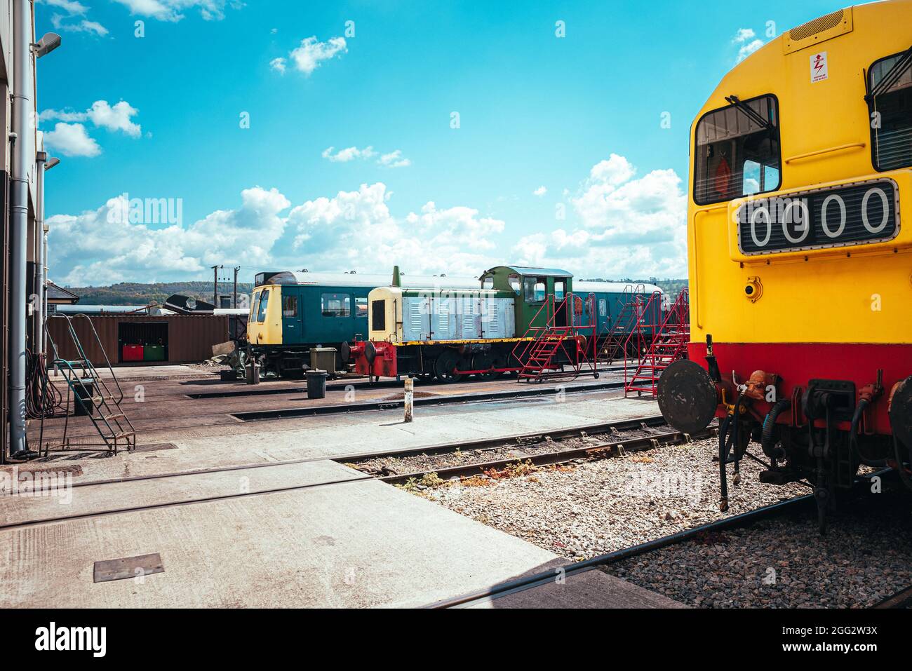 A train shed featuring old Diesel engines on blue sky sunny day Stock ...