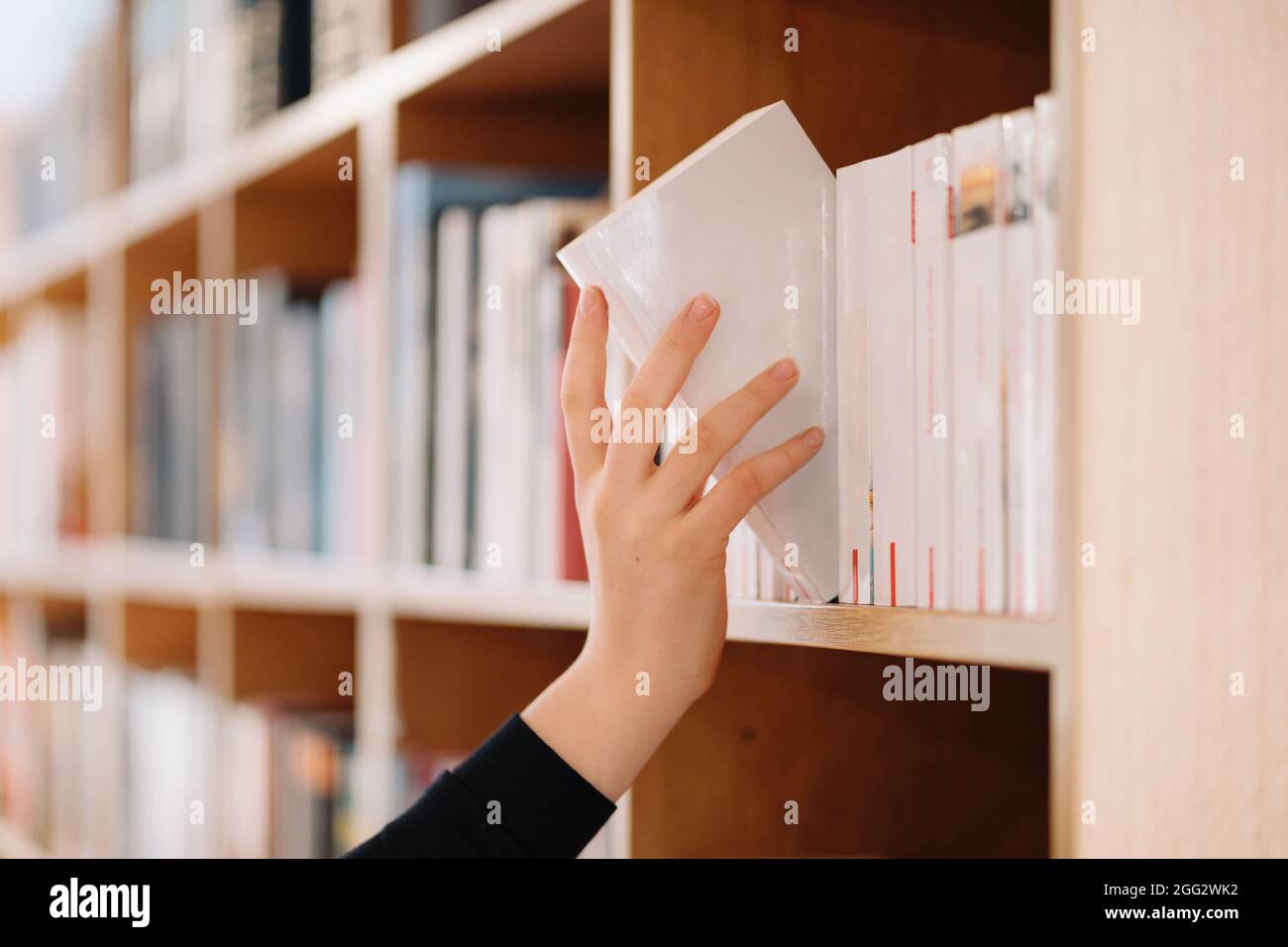 Student hand taking book from shelf in library - People, knowledge ...