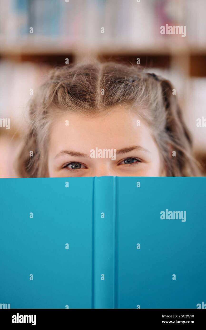 Girl head behind book hi-res stock photography and images - Alamy