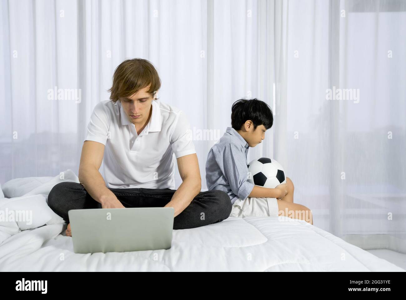 Father work at home with son. Young caucasian father using laptop ...