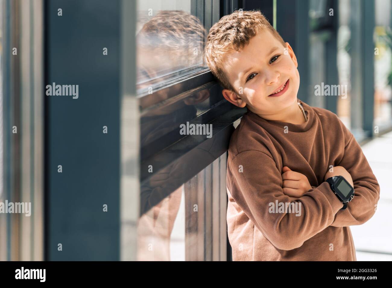 Cute modern boy leaning against the panoramic window at home Stock ...