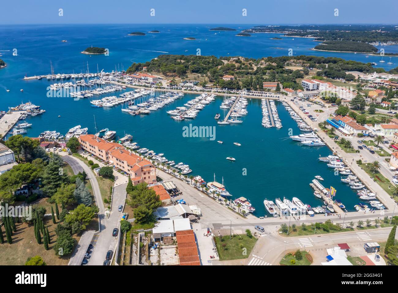 an aerial shot of coastal city Vrsar, waterfront and boats and yachts ...