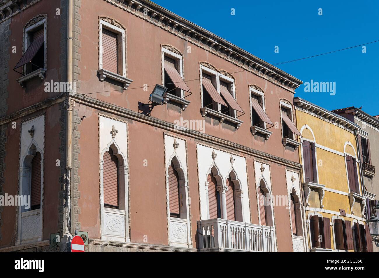 row of colorful multicolored buildings on main street Corso del Popolo ...
