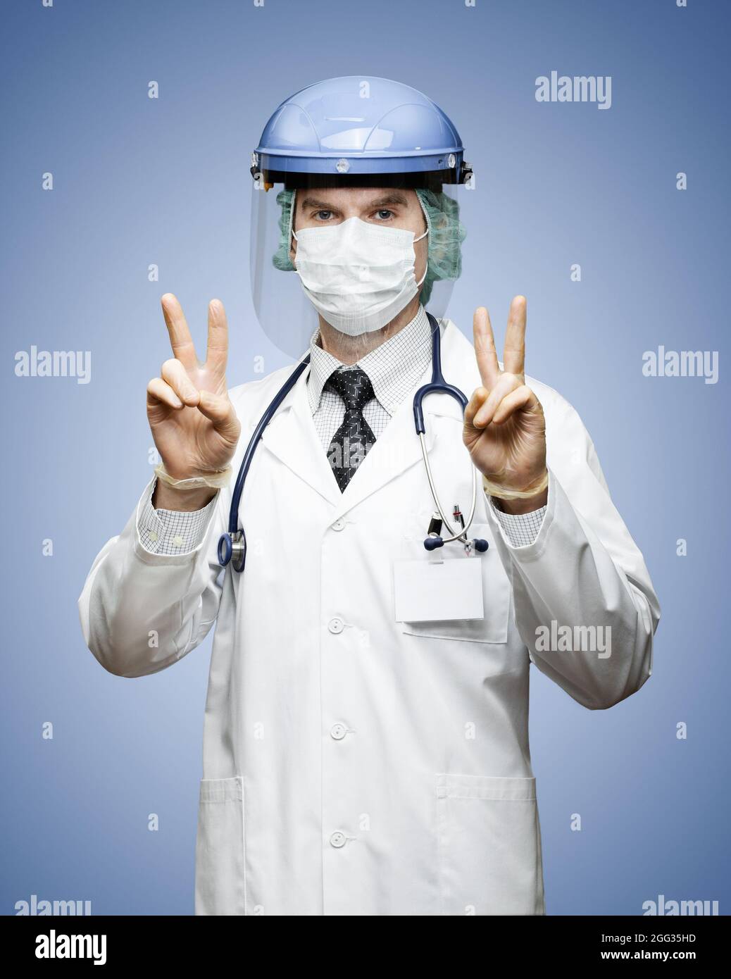 Medical doctor showing V-sign with his fingers - a simbol of victory ...