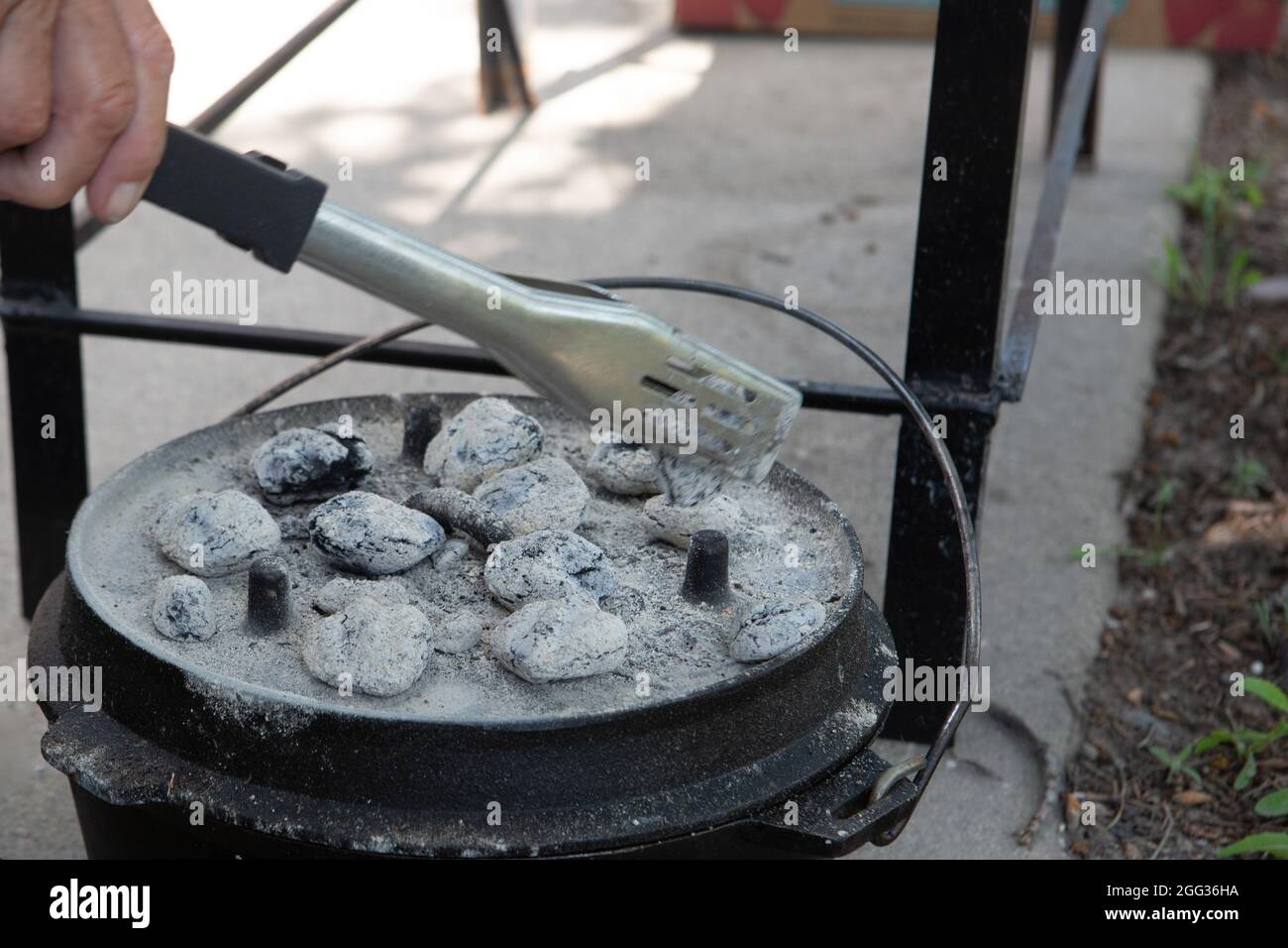 Bowl with the light gray coal for cooking in it Stock Photo - Alamy