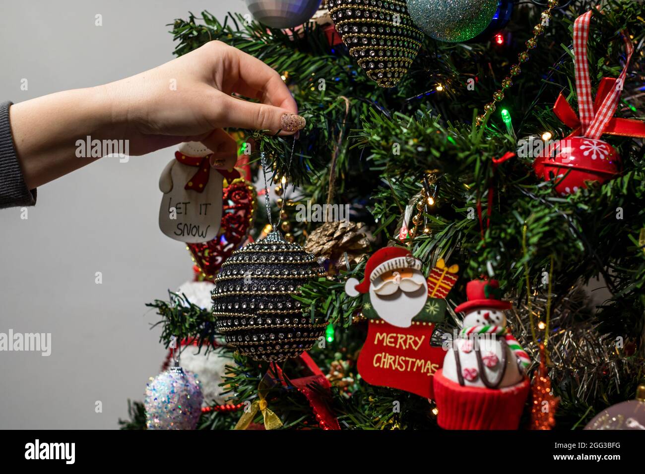 Hanging Christmas decorations and ornaments in the Christmas tree Stock ...
