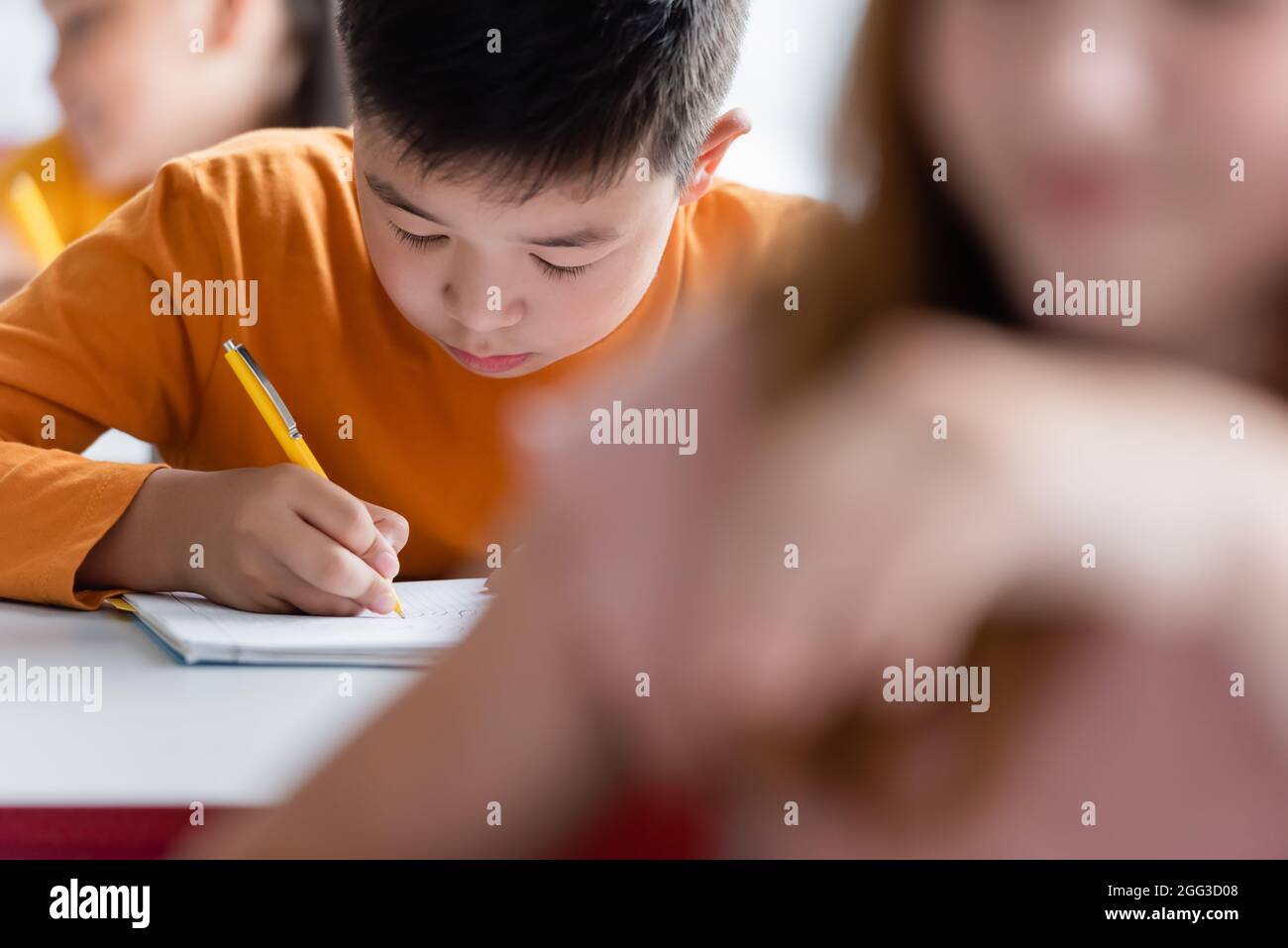 Asian boy writing hi-res stock photography and images - Alamy