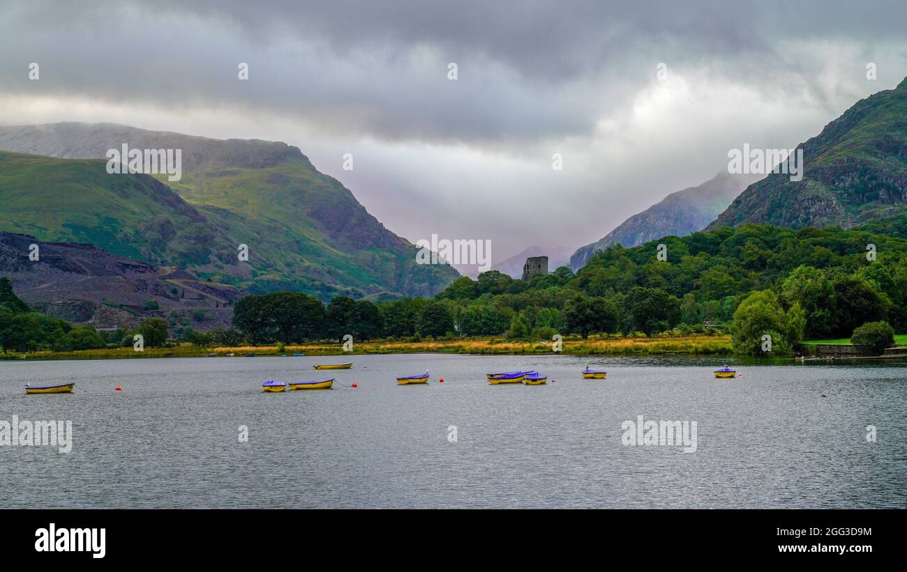 A VIEW OF LLYN PADARN AT LLANBERIS, SNOWDONIA, AS THE SUN BREAKS ...