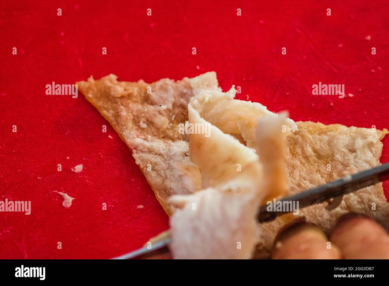 Butcher cutting little pieces of fat pork meat Stock Photo - Alamy