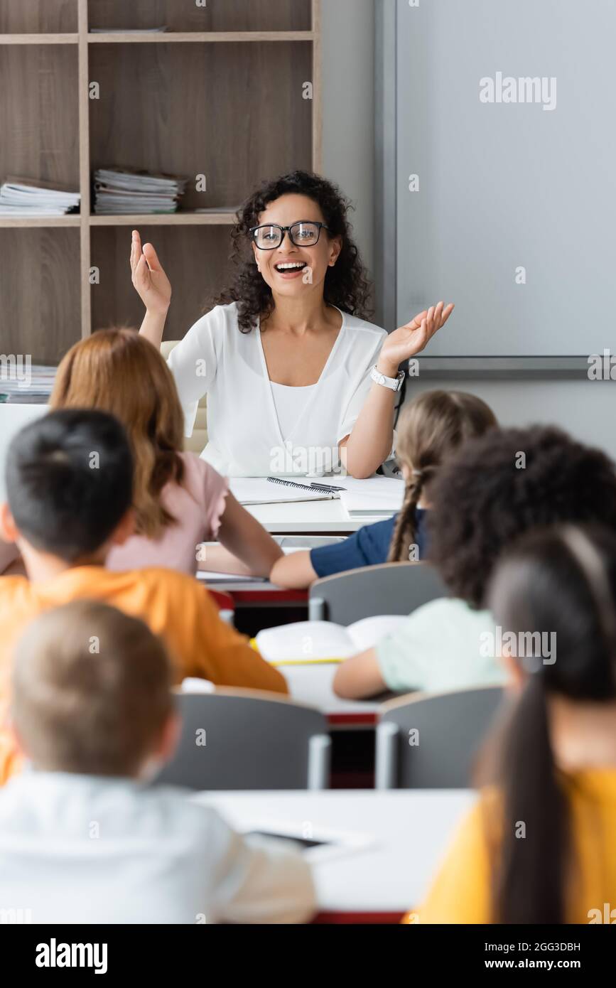 excited african american teacher showing wow gesture during lesson ...