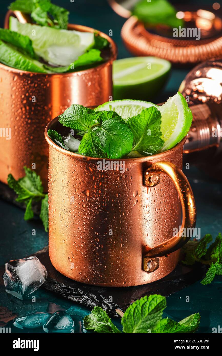Moscow mule cocktail in copper mug with lime, ice, ginger beer, vodka ...