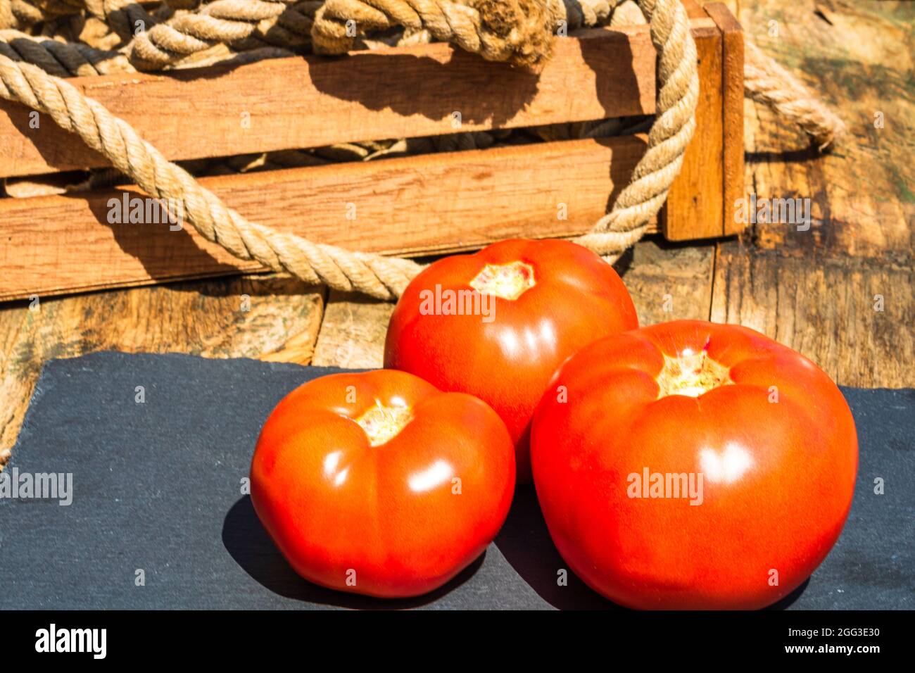 Close up of fresh ripe tomatoes isolated in a rustic composition Stock ...