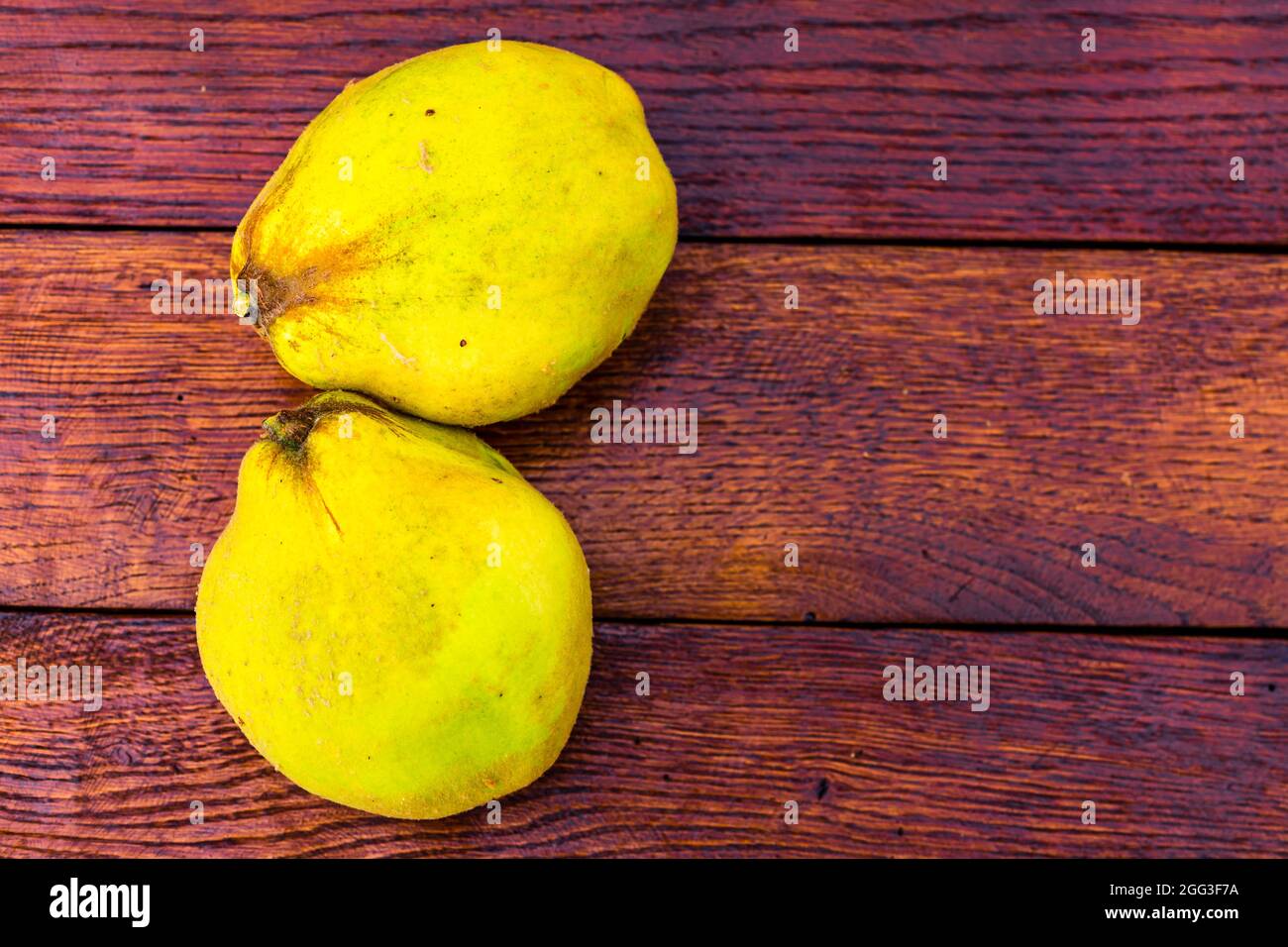 Fresh ripe yellow quince. Fruits in a wooden table Stock Photo - Alamy