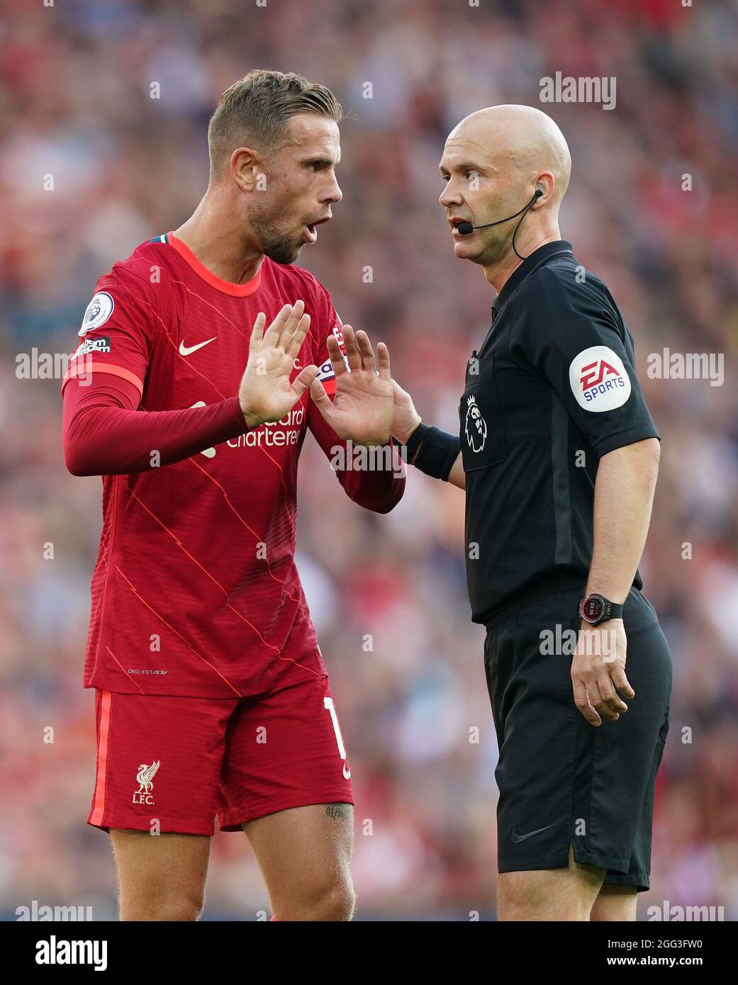 Liverpool's Jordan Henderson speaks with referee Anthony Taylor during ...