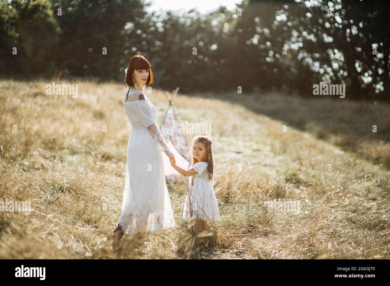 Happy family, young mother and cute little daughter, dressed in native ...