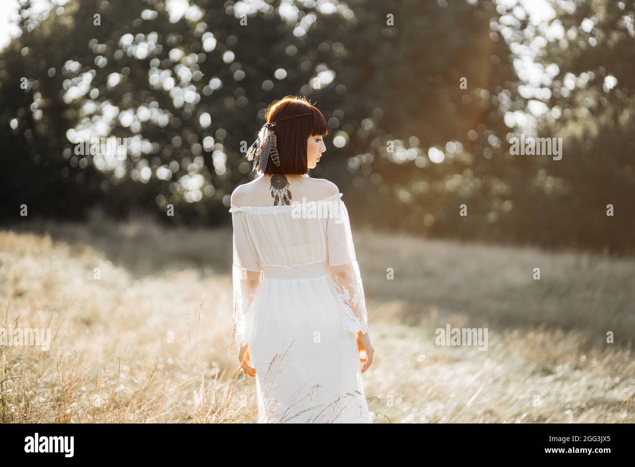 Back portrait of native indian american woman, in white boho dress ...