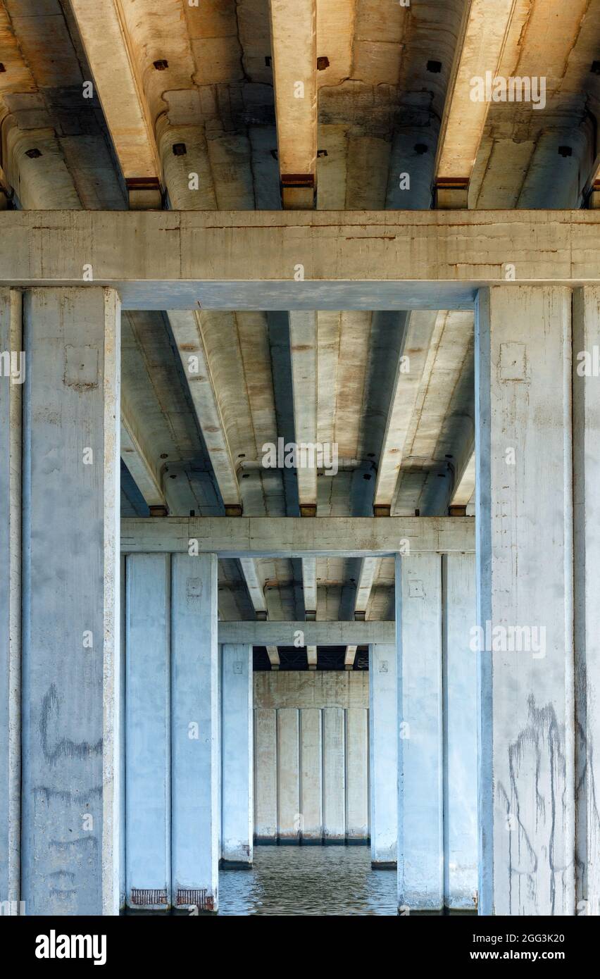 The concrete structures of the bridge trusses are laid across the river ...