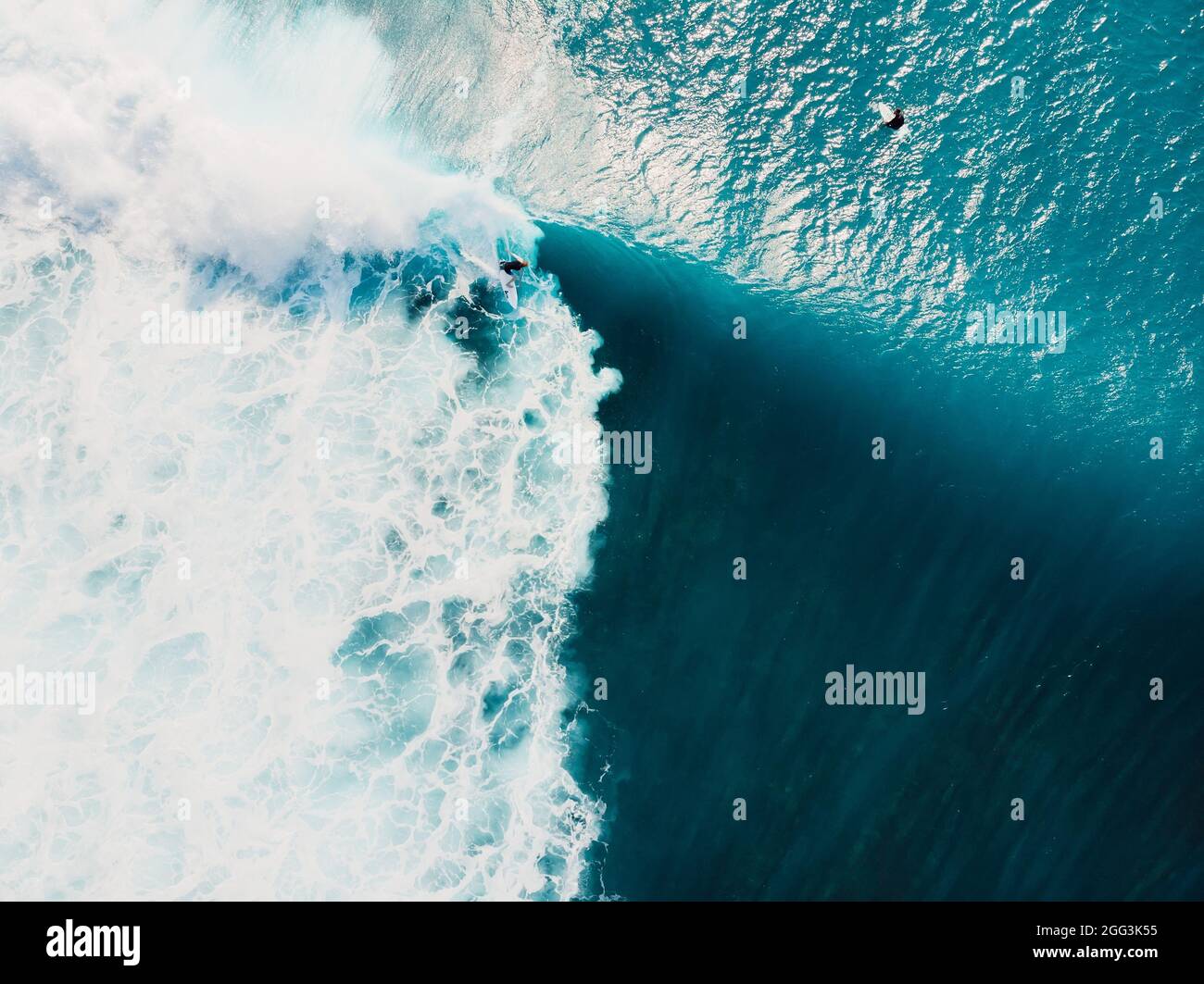 Aerial view of surfer on barrel wave in tropical blue ocean. Top view ...