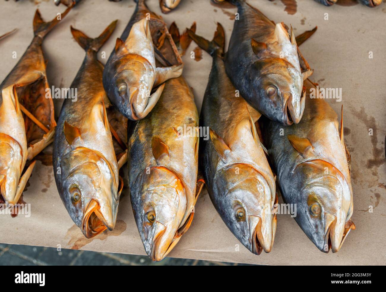 Smoked salted fish on a paper at outdoors seafood market Stock Photo ...