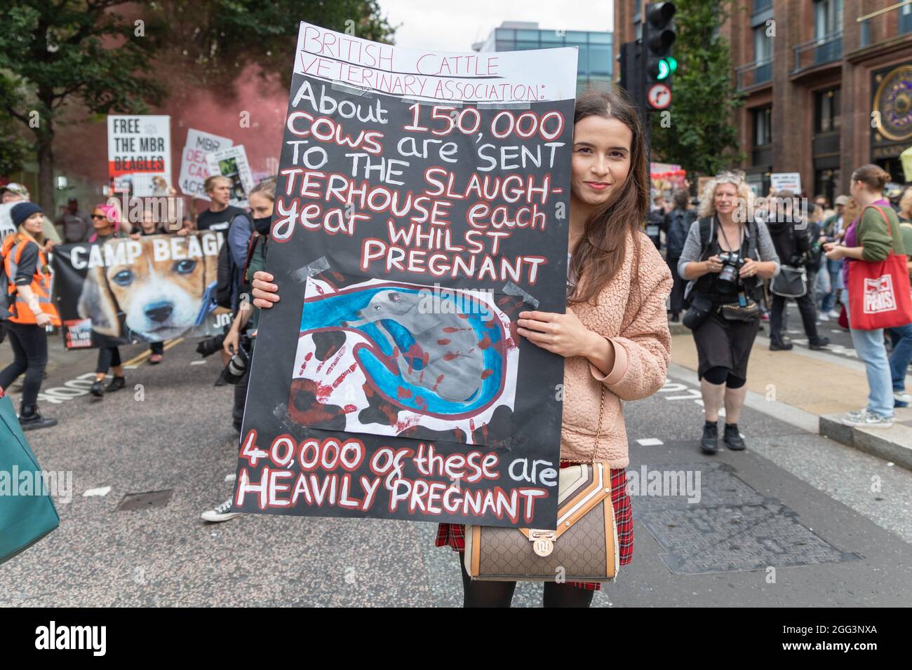 London, UK. 28th Aug, 2021. A demonstrator holds a graphic sign ...