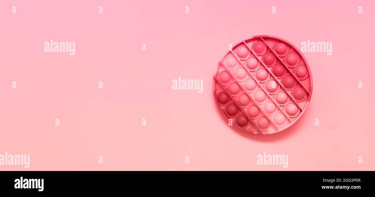 Color pop it fidget toys on orange background, flat lay Stock Photo - Alamy