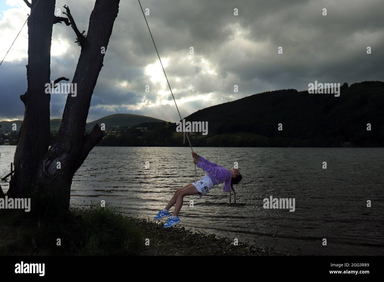 Girl swinging over sea hi-res stock photography and images - Alamy