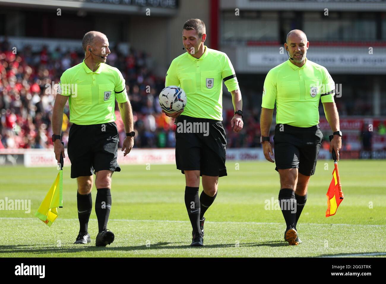 Assistant referee Geoffrey Liddle, Referee Matthew Donohue and ...