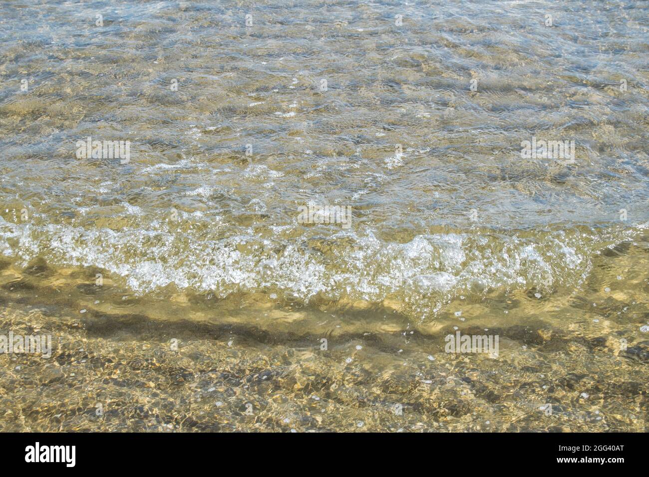 Wave of the sea breaking on the shore of a beach. Background and ...