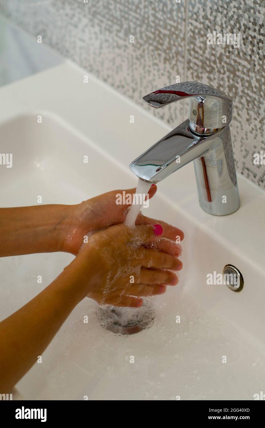 Person washing hands hi-res stock photography and images - Alamy