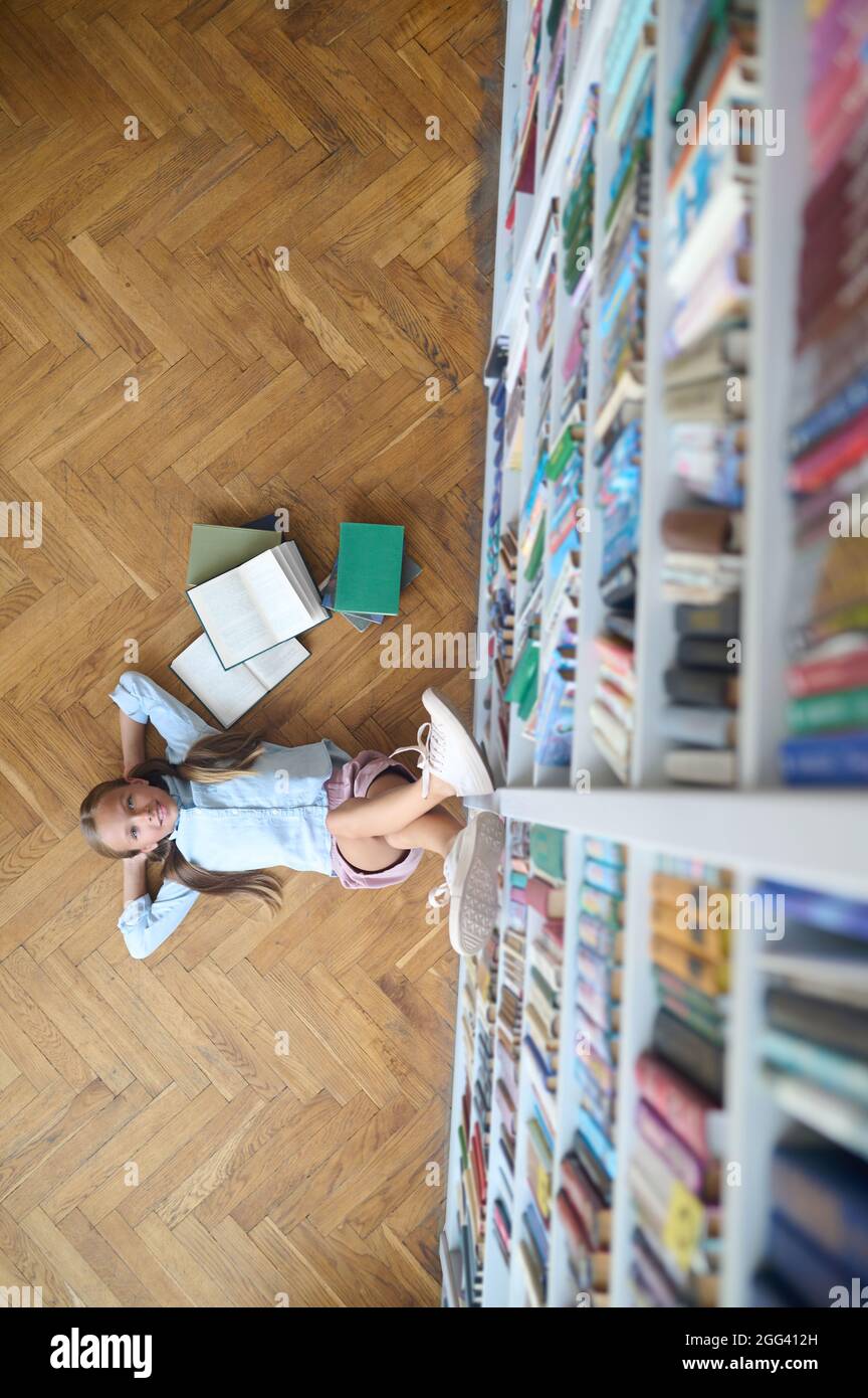 Pretty Caucasian pupil taking a break from reading books Stock Photo ...