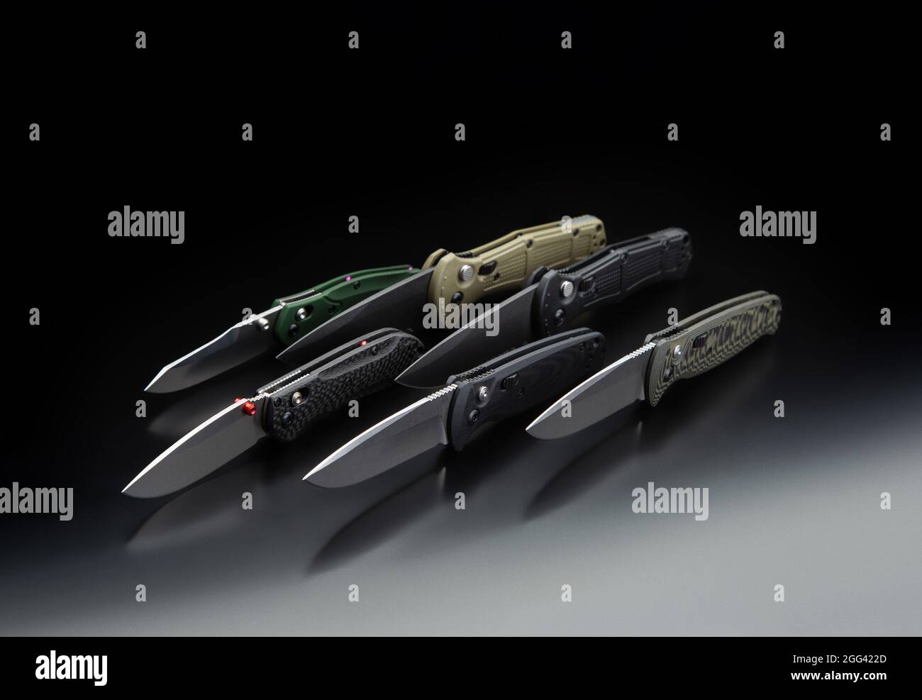 Various folding pocket knives on a dark background. A versatile pocket ...