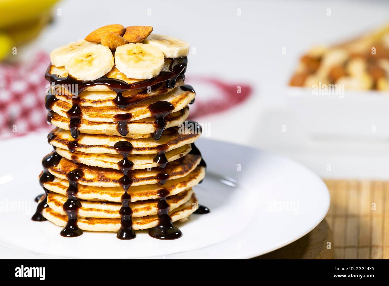 Pancakes with Chocolate Syrup, Nuts and Bananas. Stack of whole ...