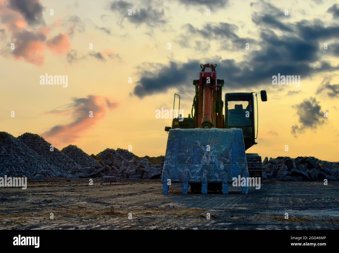 Recycling concrete and construction waste from demolition. Excavator at ...
