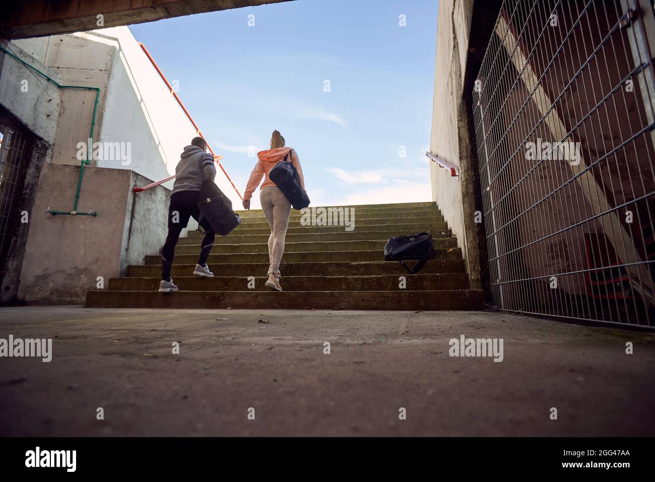 Activity runners holds sport bag and going at training on stadium Stock ...