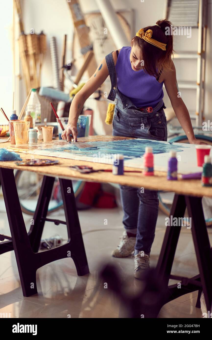Cute female painter artist creating a new piece in the studio Stock ...