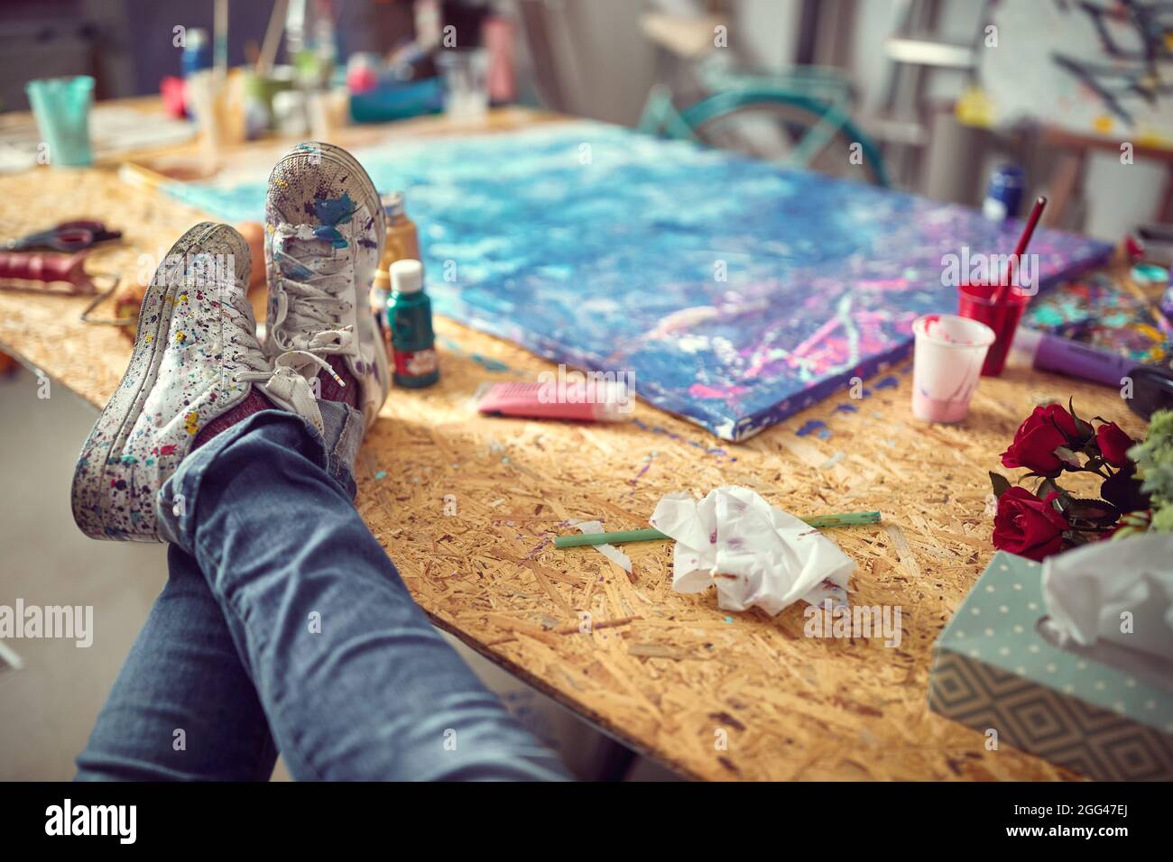 Female artist relaxing after completing a new piece in the studio Stock ...