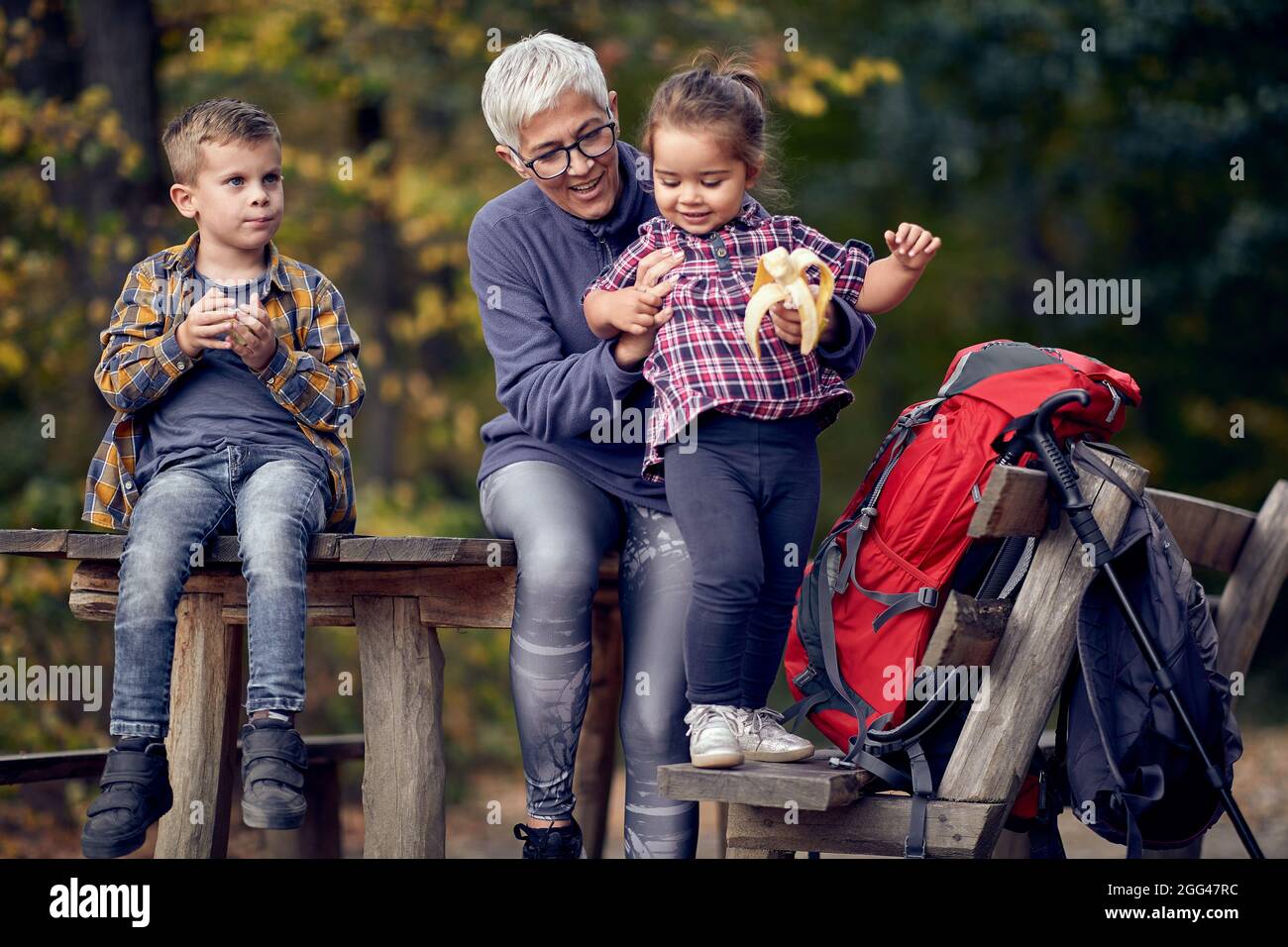 Grandmother and grandchildren playing in the forest on a beautiful ...