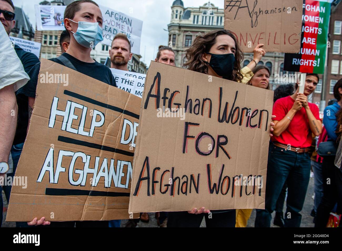 Amsterdam, Netherlands. 28th Aug, 2021. Protesters hold placards during ...