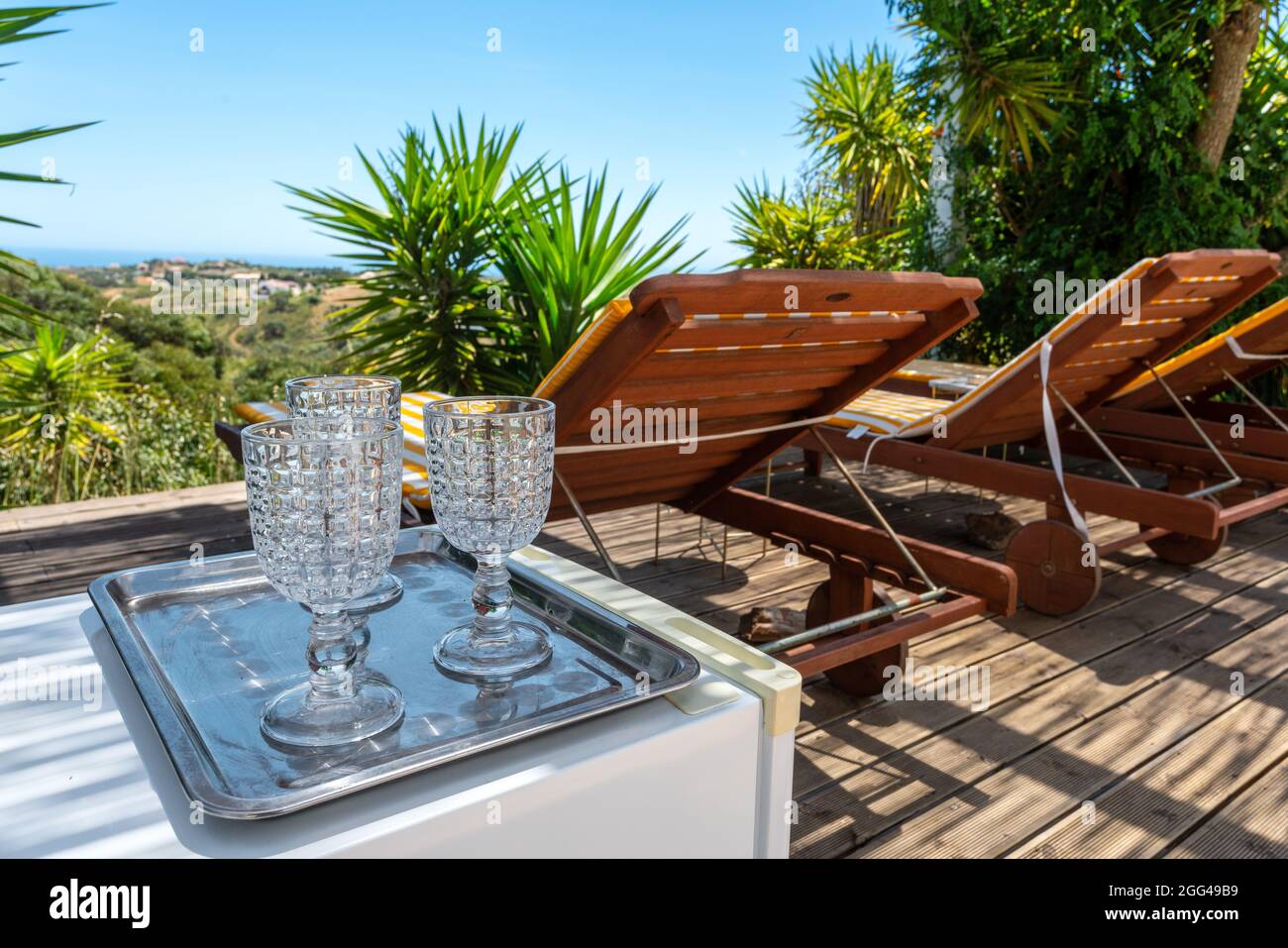 Sun beds for sunbathing with a beautiful view of nature, and a tray ...