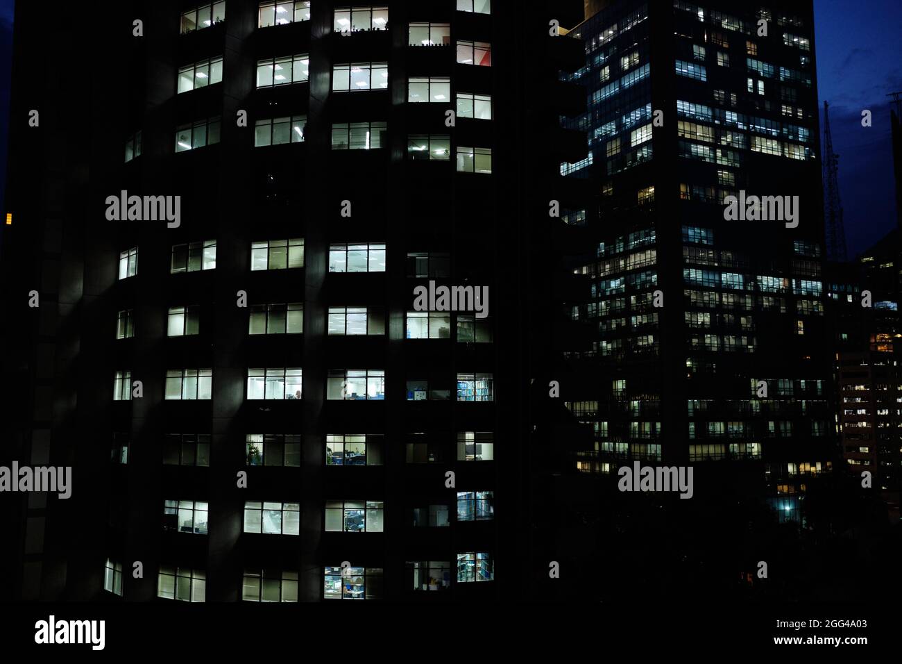 Office Buildings at night with lightened windows Stock Photo - Alamy