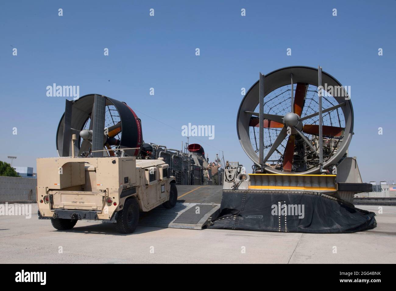 210826-N-WP865-1238 KUWAIT (Aug. 26, 2021) A Humvee is loaded onto ...