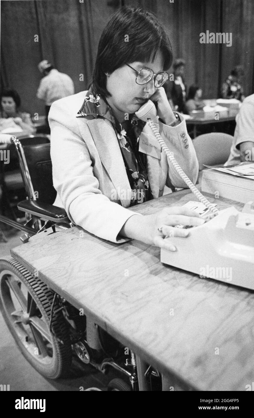 Austin Texas USA, circa 1985: Handicapped woman in wheelchair talks on ...