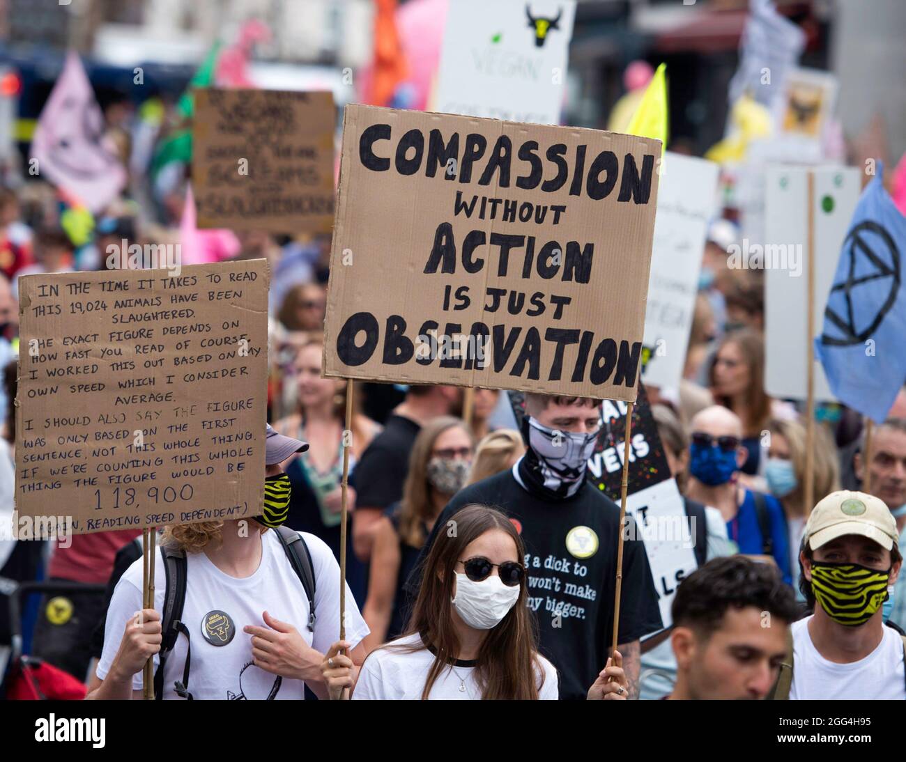 London, UK. 28th Aug, 2021. Activists march with placards expressing ...