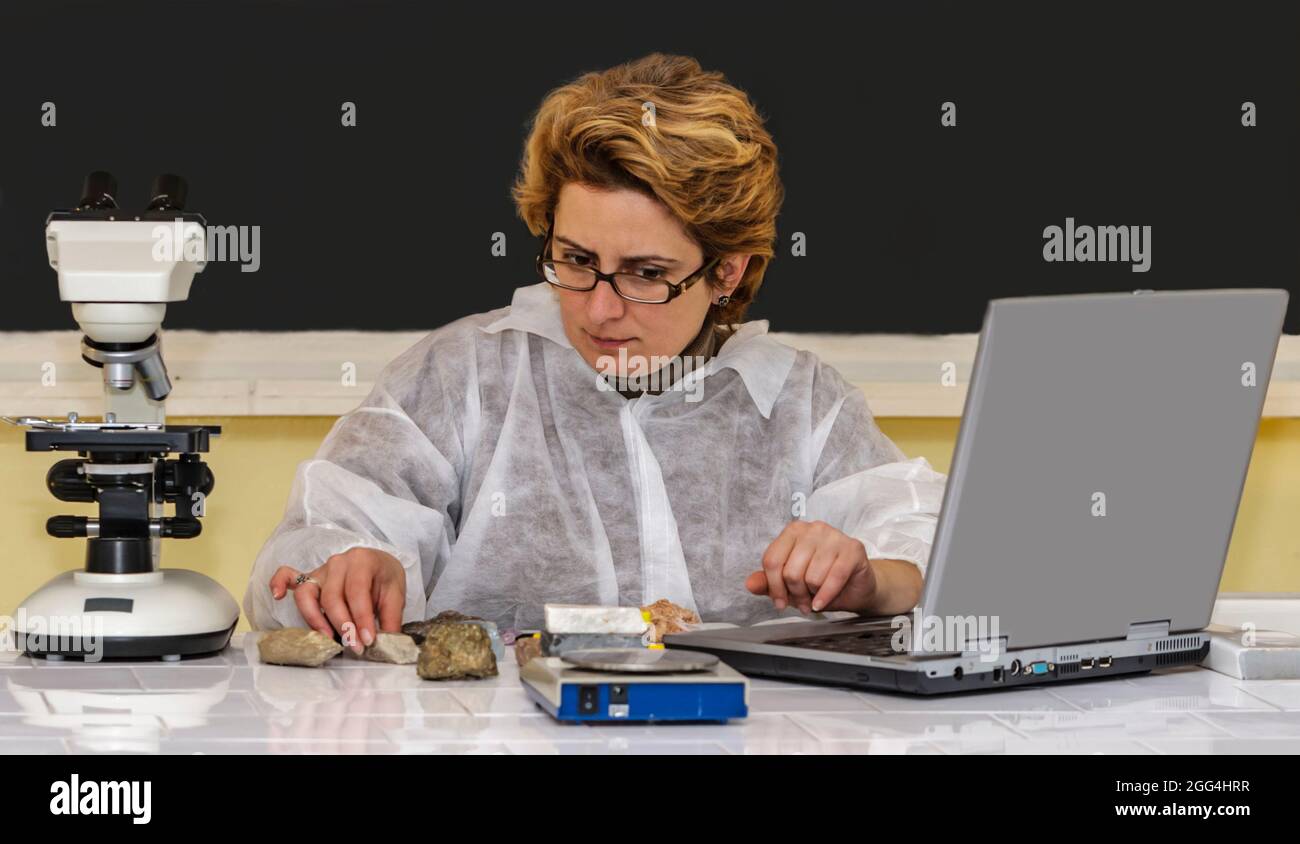 Female geologist researcher analysing a rock at her workplace Stock ...