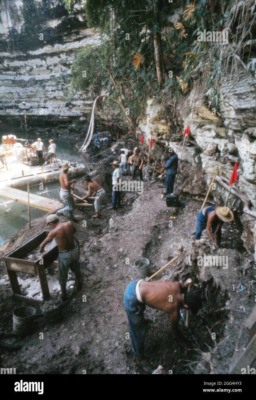 View of the archeological team at the Sacred Cenote of Chichen Itza in ...